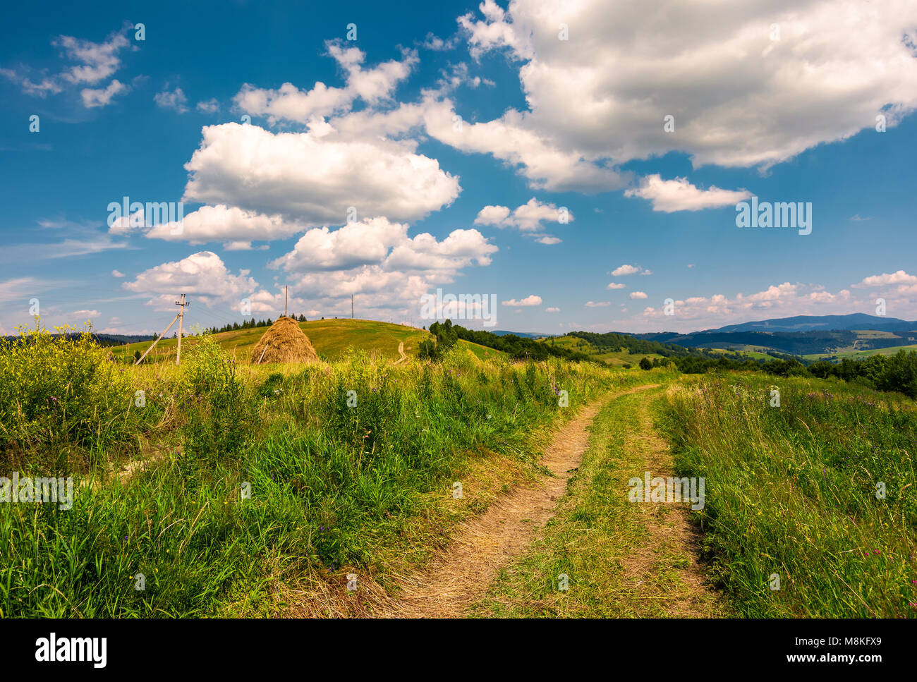 country road along the hillside. lovely countryside rural scenery in ...