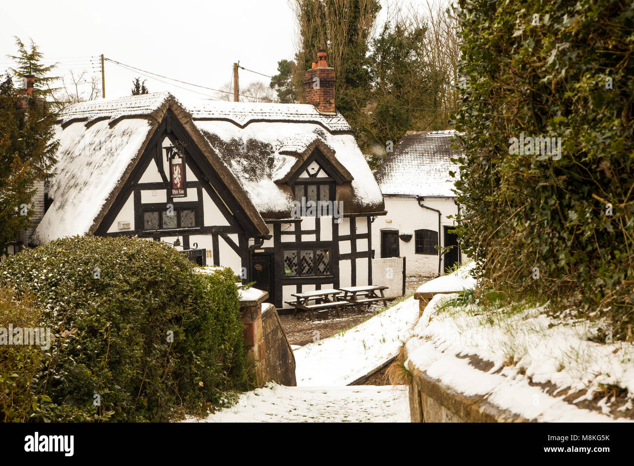 Snow covered black and white half timbered houses and the White Lion ...