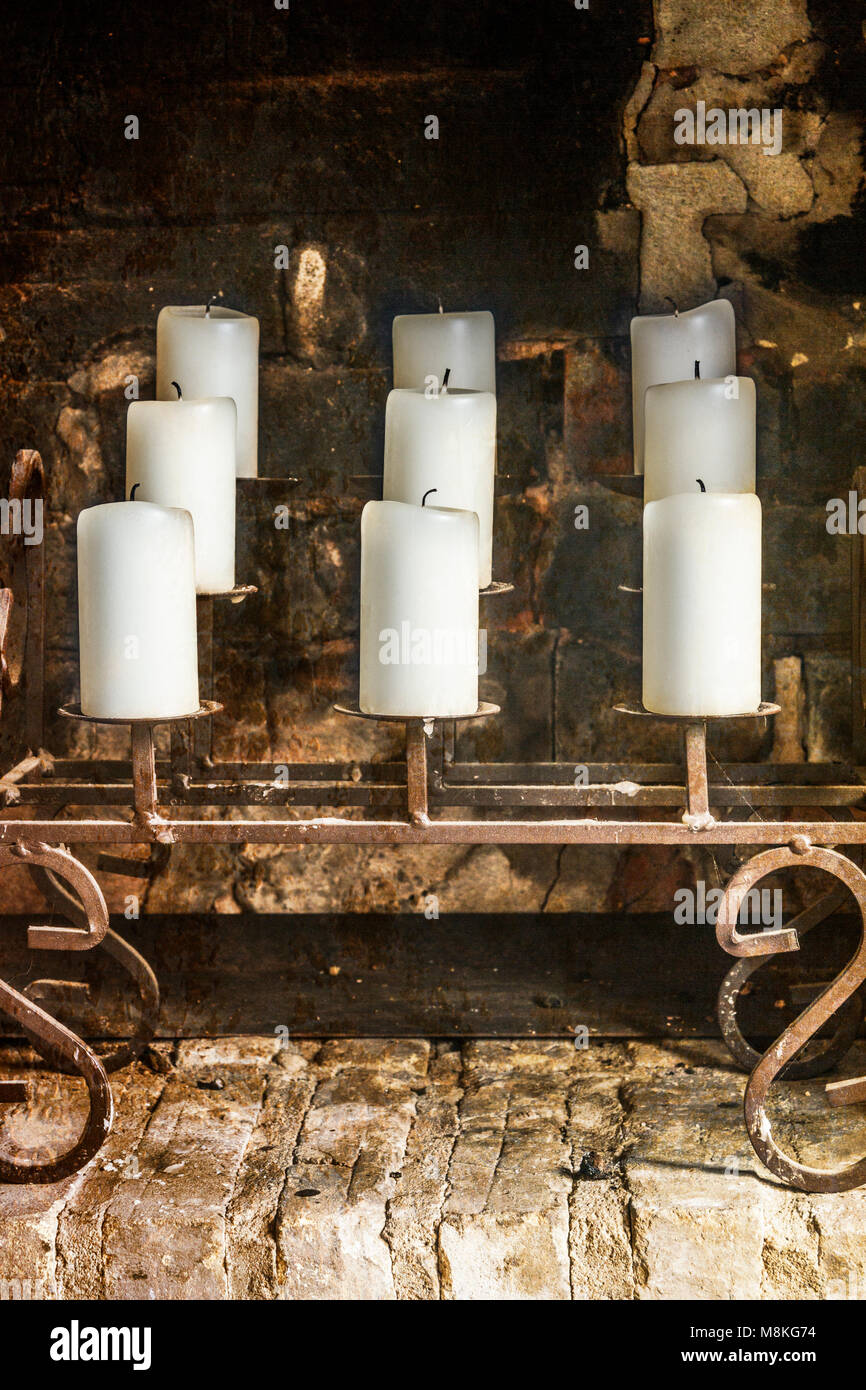 Candles on a frame in a stone fireplace Stock Photo - Alamy