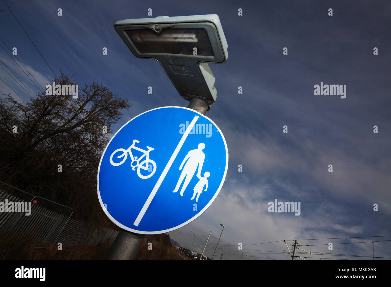 A sign showing the split between the designated lanes for pedestrians ...