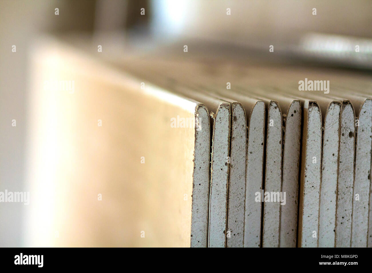 Stack of drywall plates leaning against a wall Stock Photo - Alamy