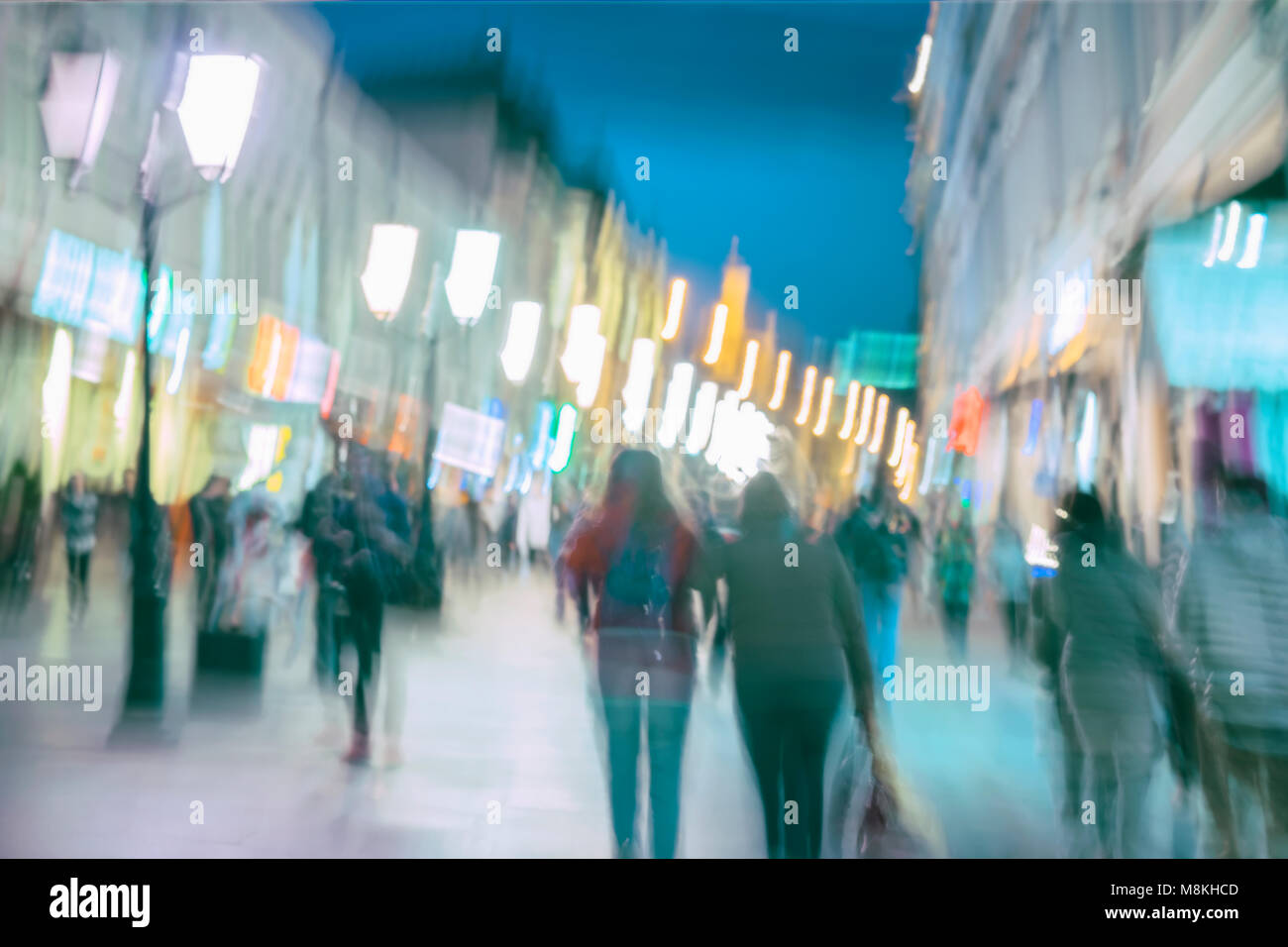 Abstract image of unrecognizable silhouettes of people walking in the ...