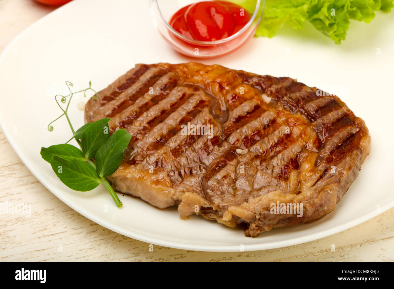 Grilled Rib eye steak with sauce Stock Photo - Alamy