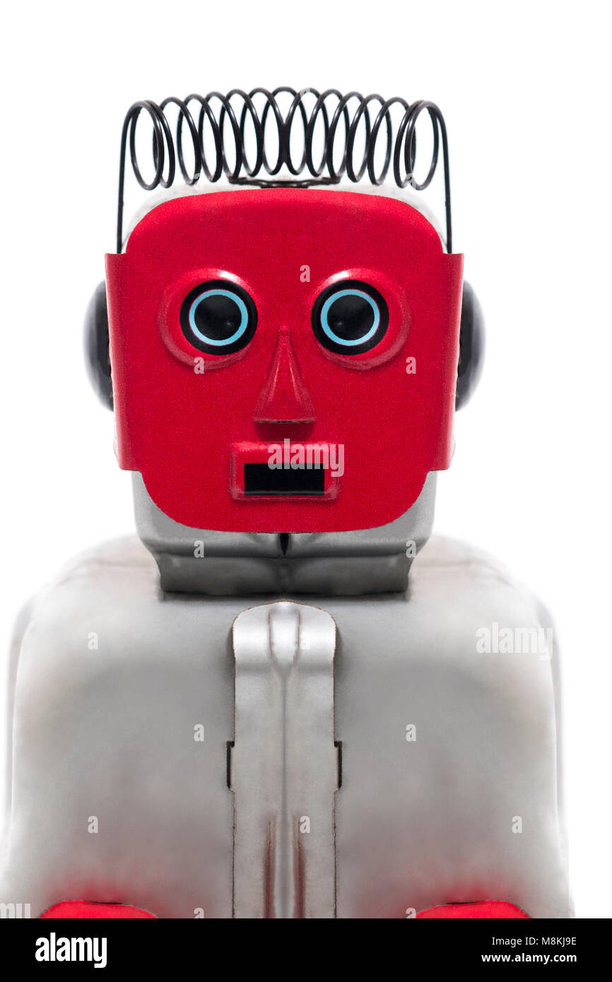 Vintage retro red face tin toy robot isolated on a white background ...