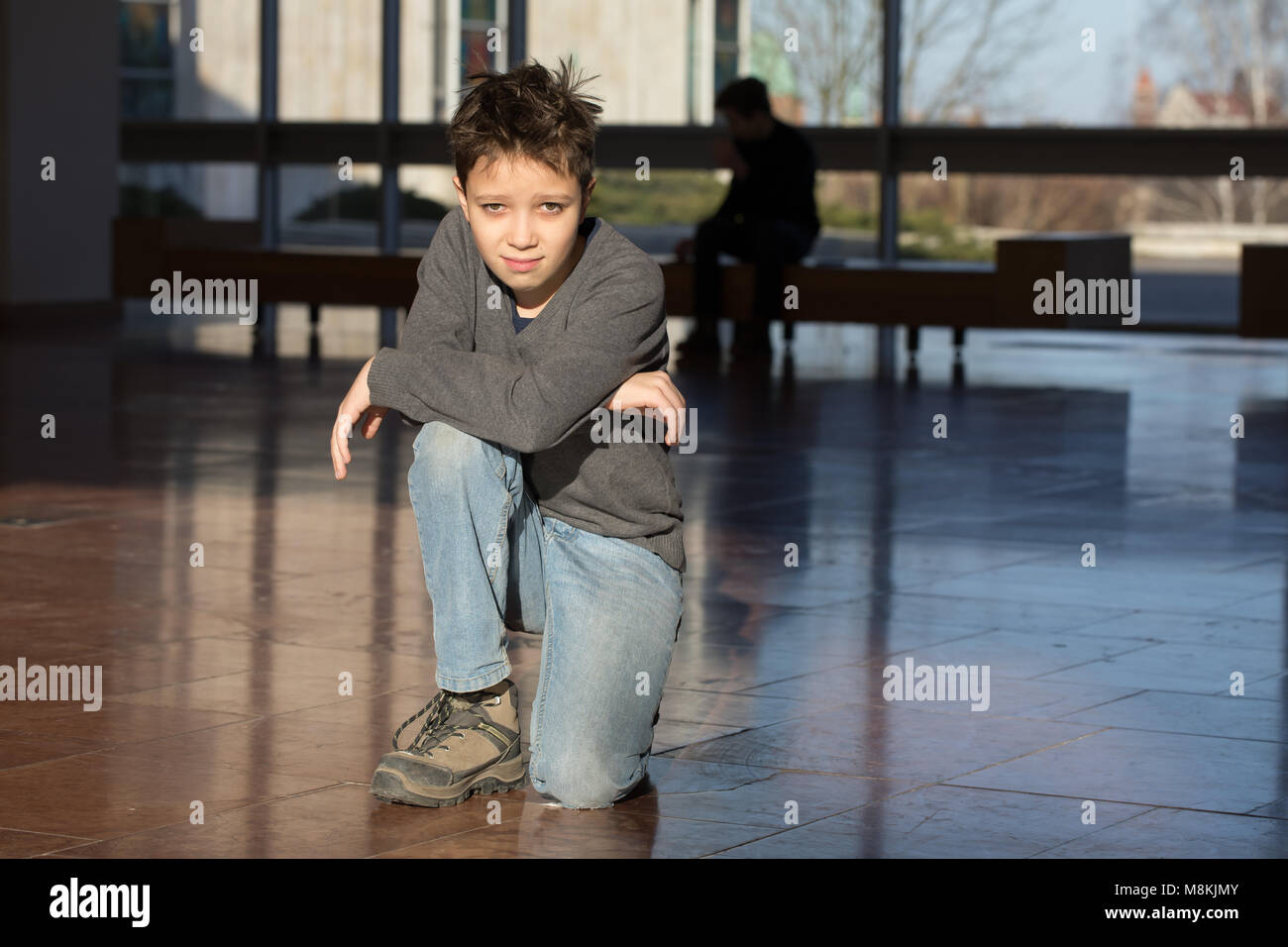 Kid kneeling hi-res stock photography and images - Alamy