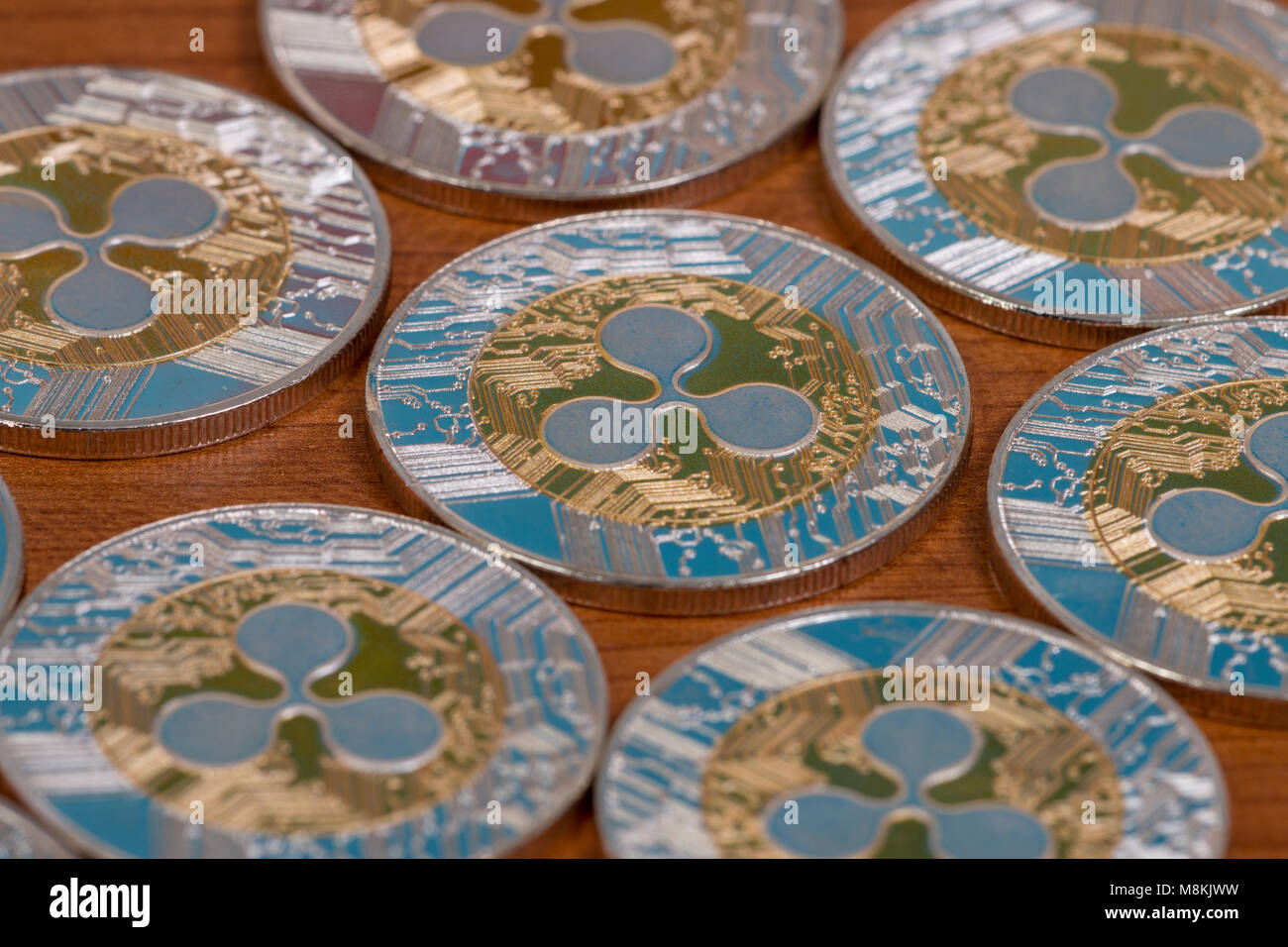 several aligned ripple coins on top of wooden table Stock Photo - Alamy