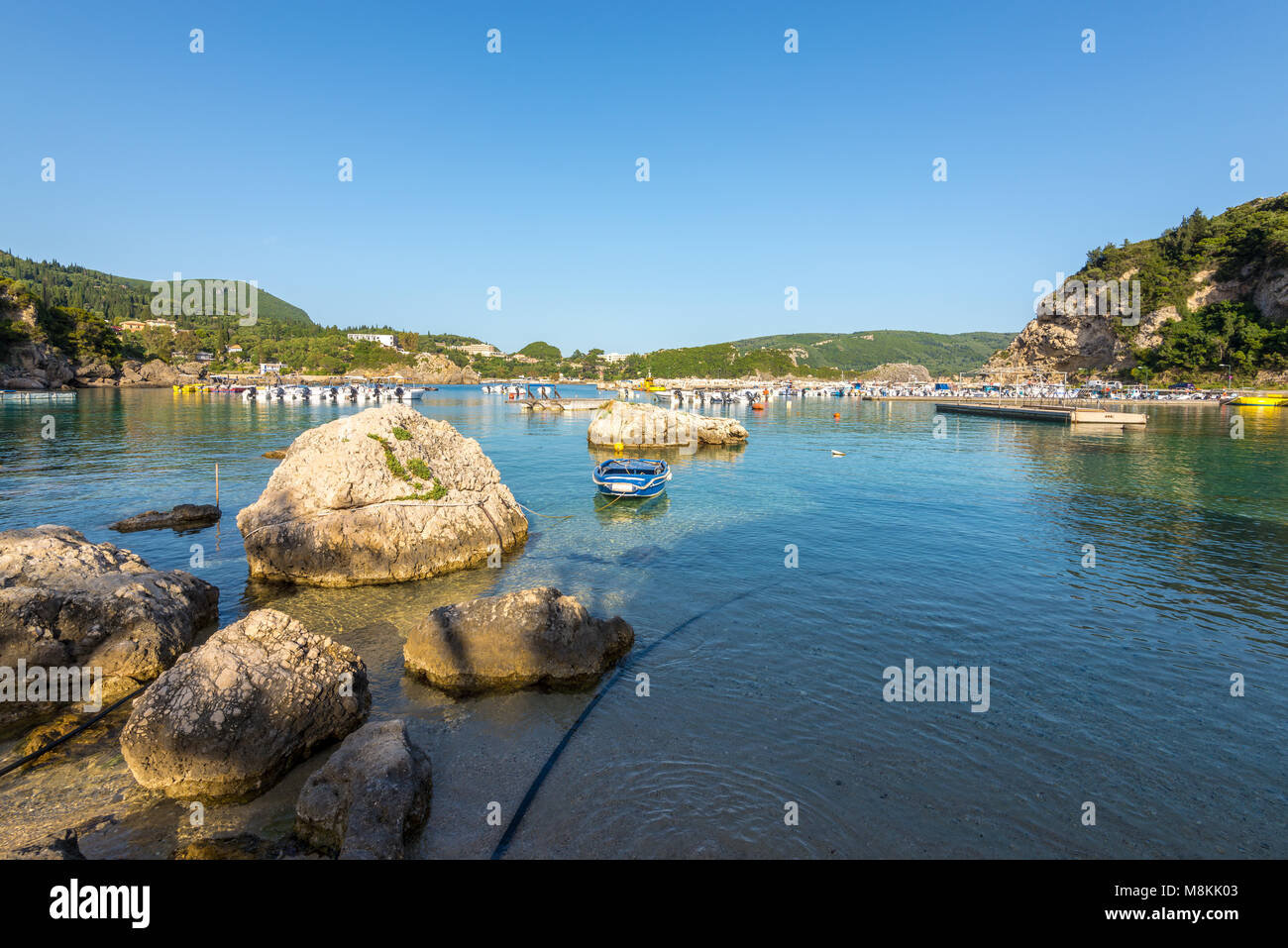 Alipa beach in Paleokastritsa bay with sand and crystal sea water ...