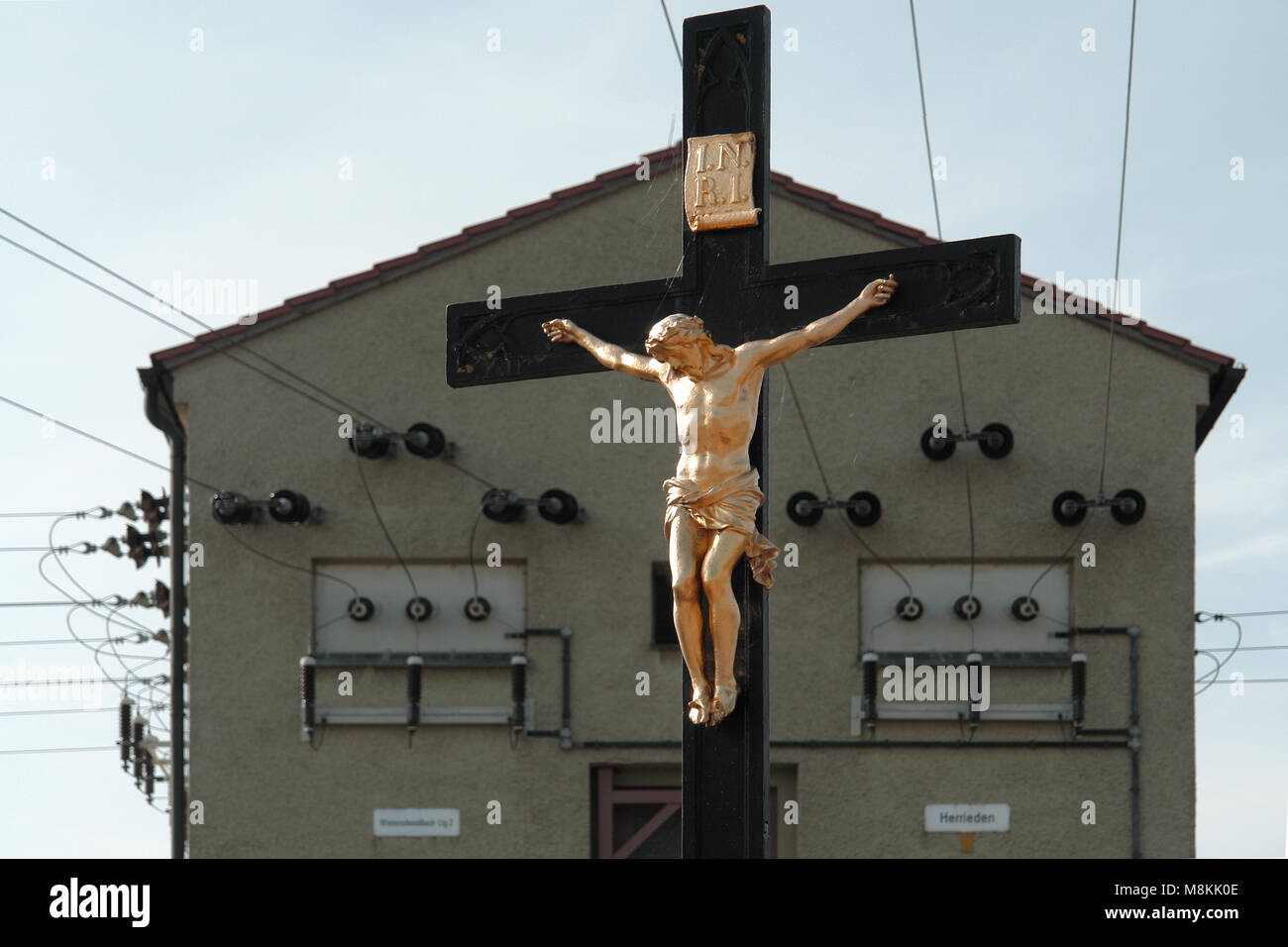 A crucifix - golden sculpture of Jesus Christ hanging on a wooden cross ...