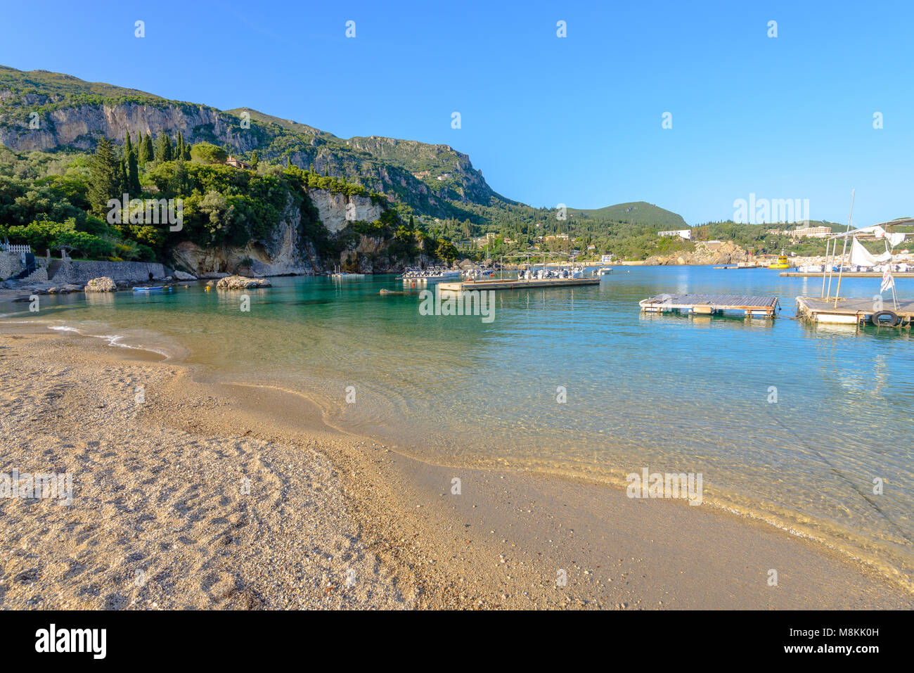 Alipa beach in Paleokastritsa bay with sand and crystal sea water ...