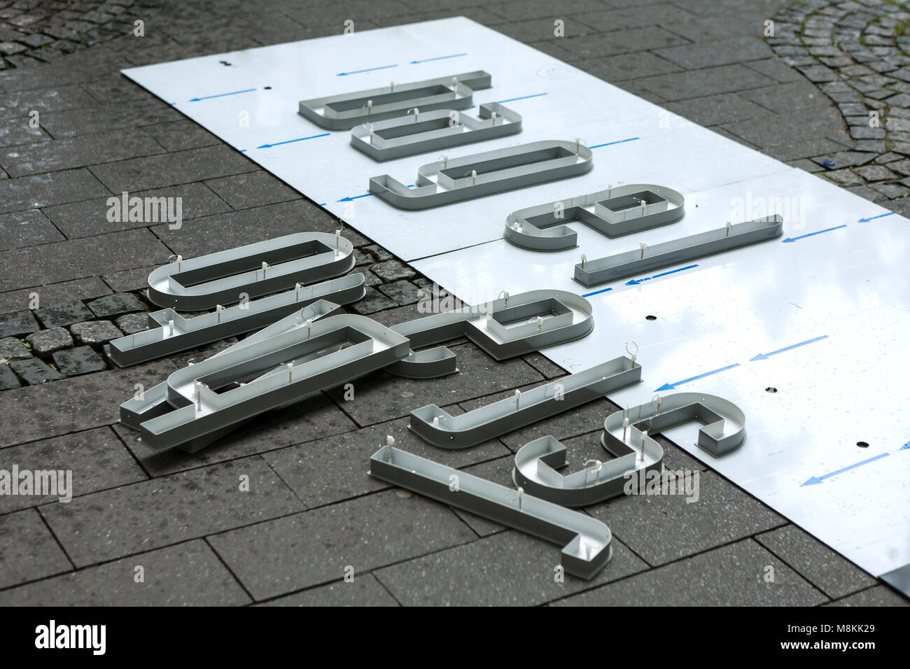 Single letters of a neon-sign laying on the ground before being ...