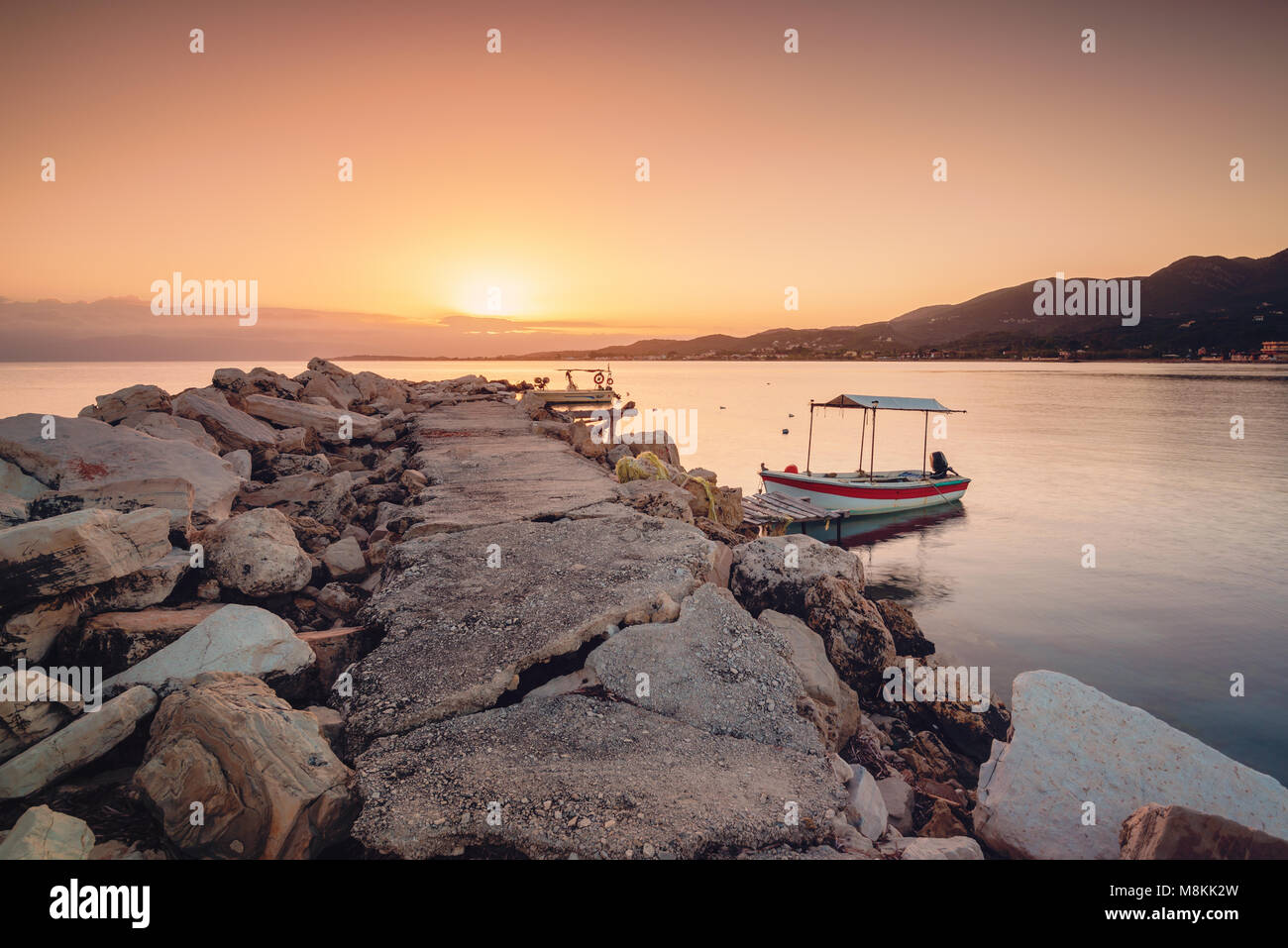 Boat anchoring in port of Roda village. Sunrise time. Corfu island ...