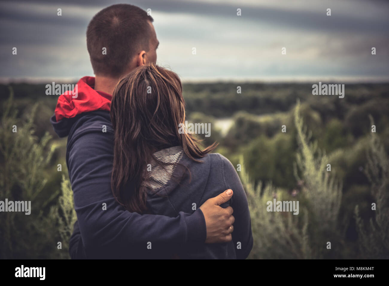 Young couple man woman together embracing looking hope into the ...