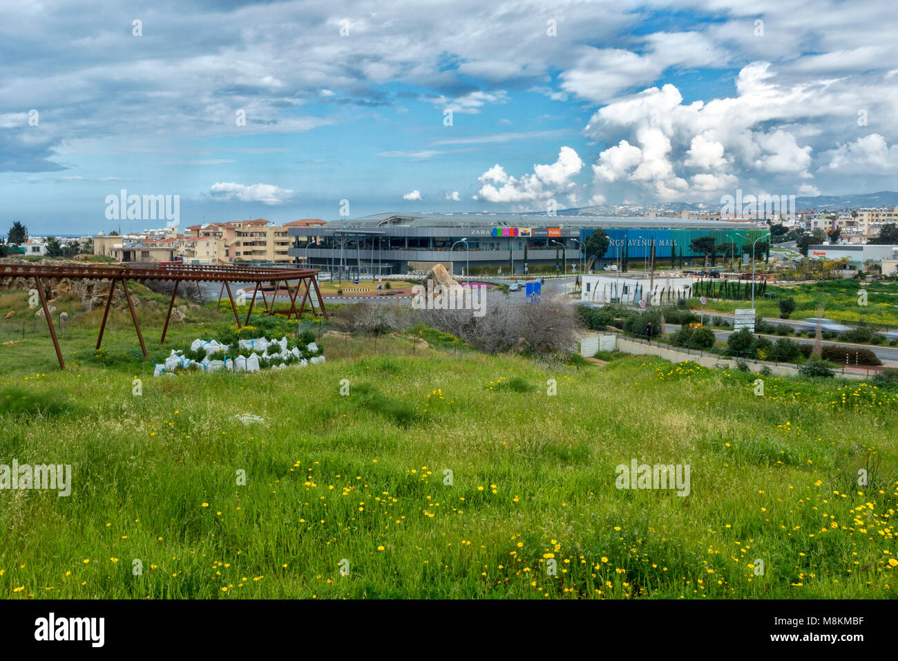 Meadow in Paphos tourist area with monorail in the mid ground and Kings ...