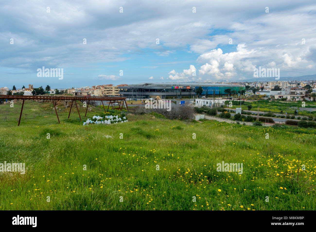 Meadow in Paphos tourist area with monorail in the mid ground and Kings ...