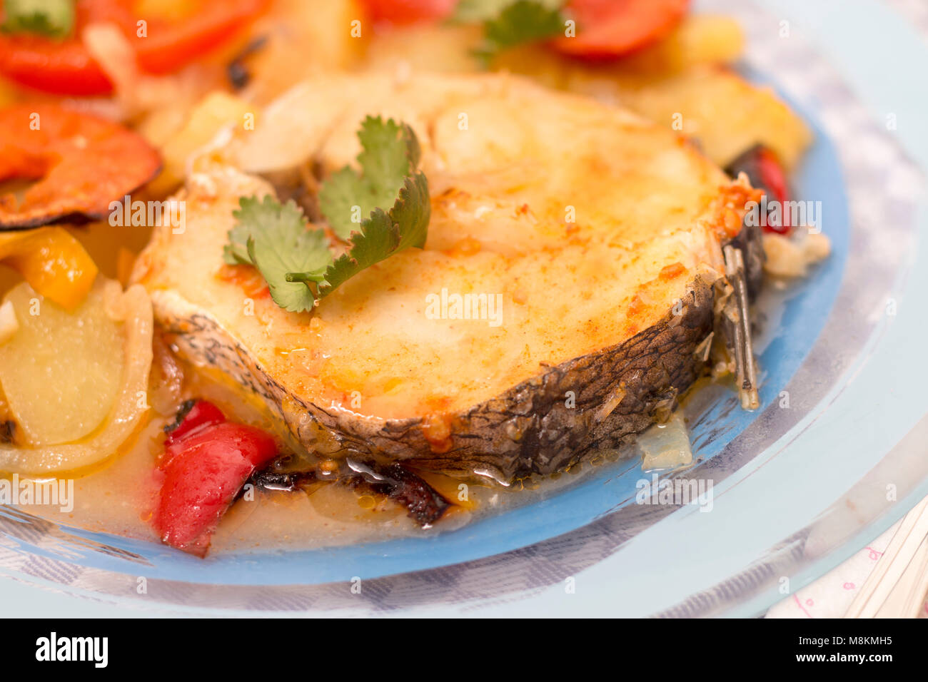 Traditional portuguese meal of fish with potatoes and tomato, made on ...