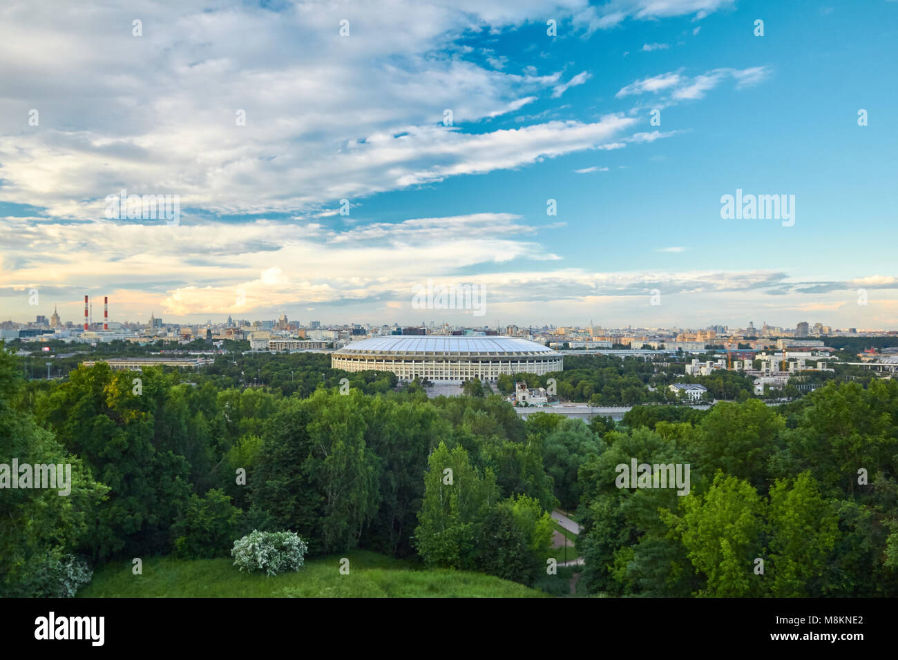 Urban landscape with a sports stadium at sunset Stock Photo - Alamy
