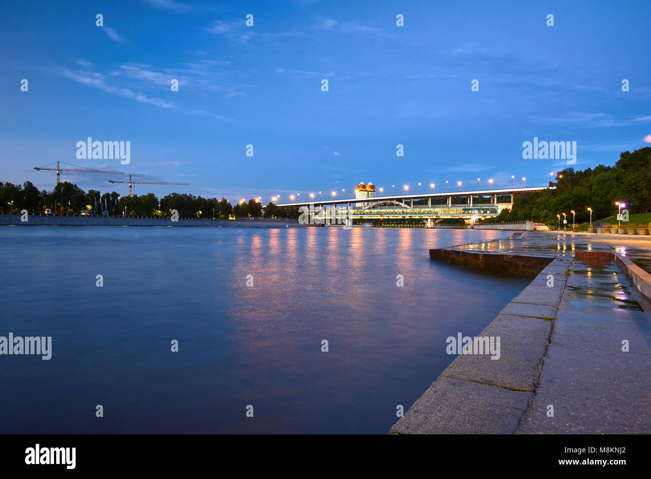 Urban landscape with river traffic at dusk Stock Photo - Alamy