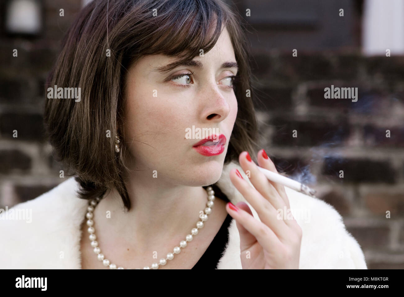Posh girl smoking a cigarette hi-res stock photography and images - Alamy