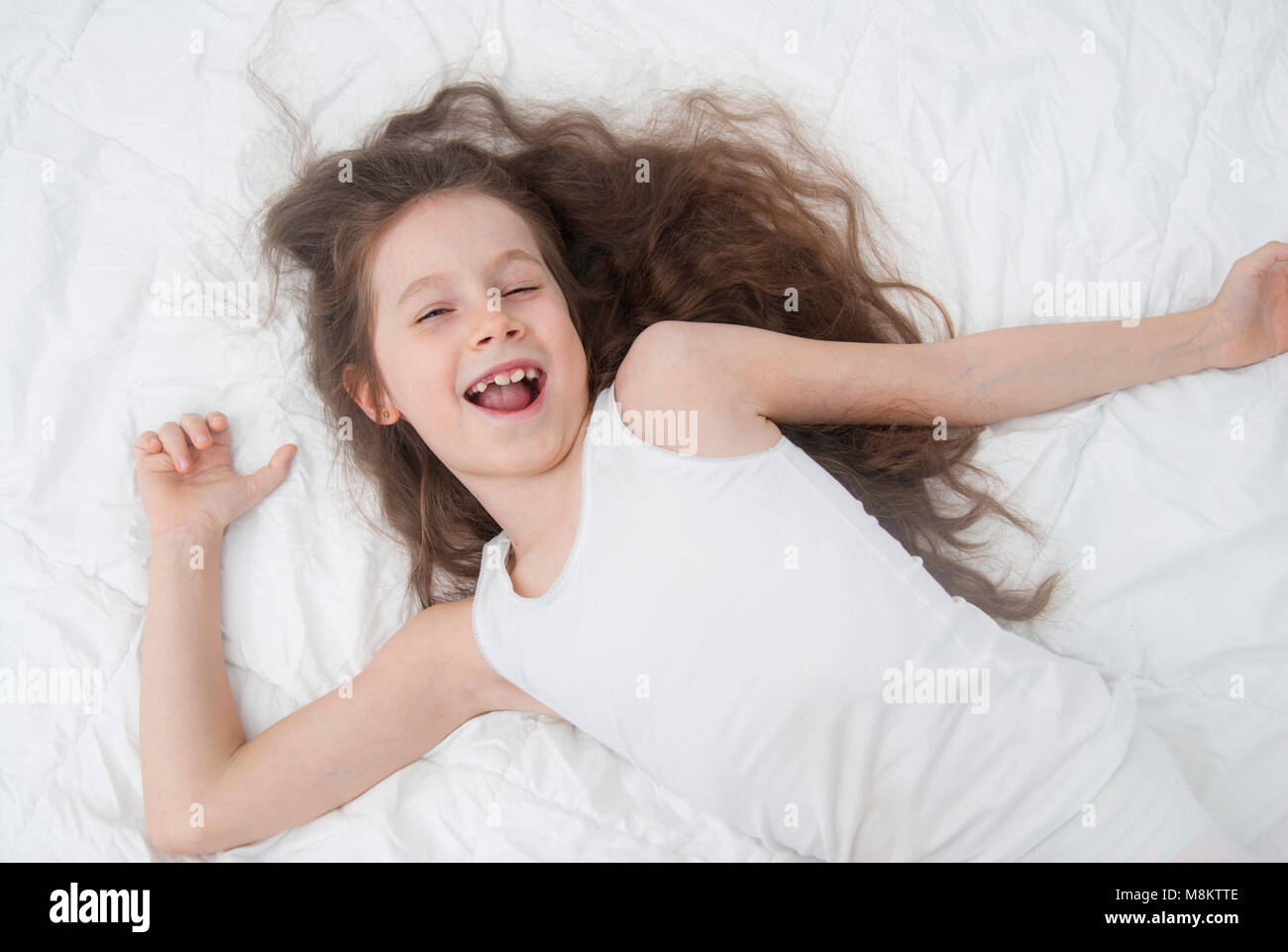 Cute Smiling Little Girl Woke up in White Bed. Morning in Wekeend. Flat ...