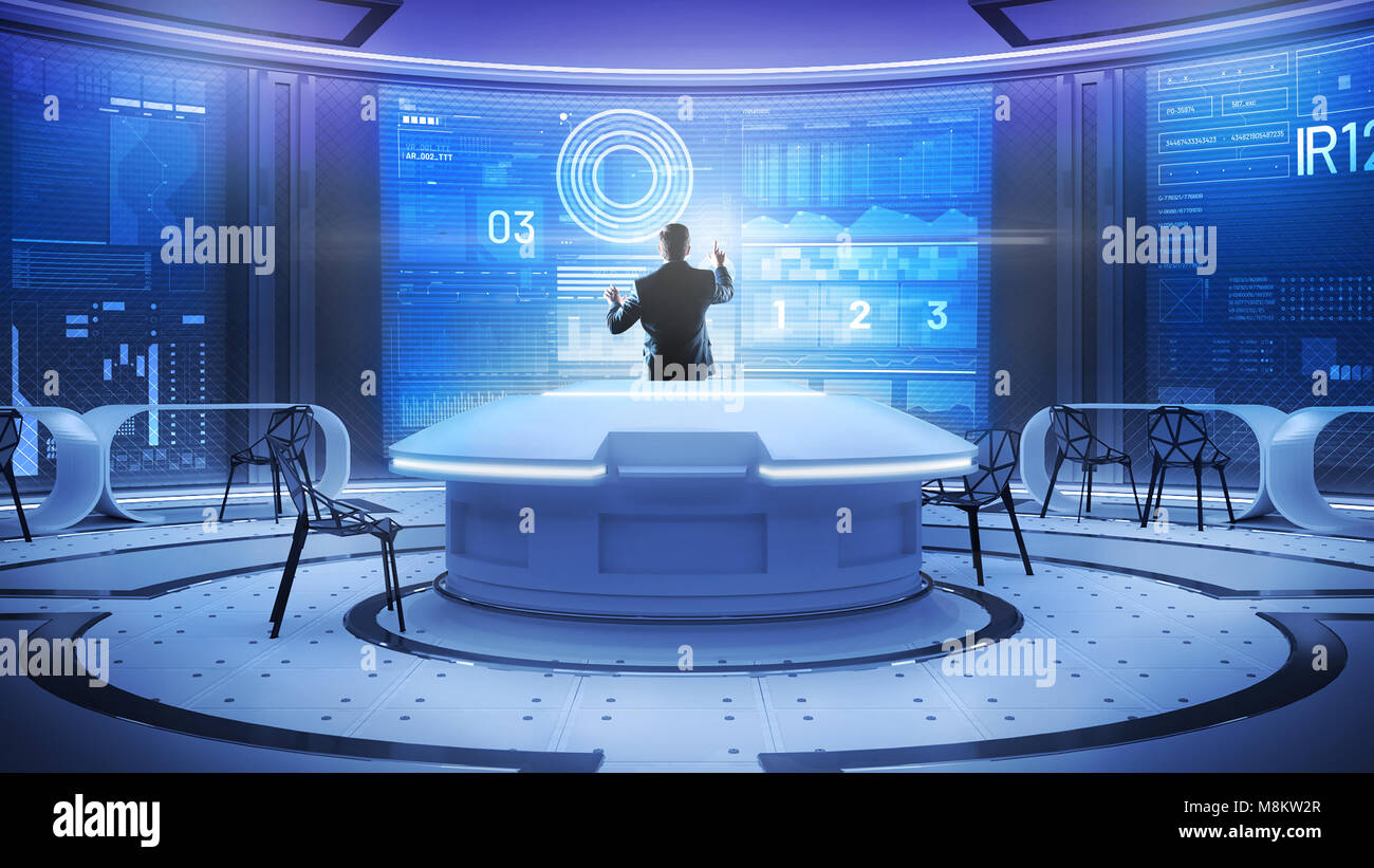 Professional programmer standing with his back to the table and working ...