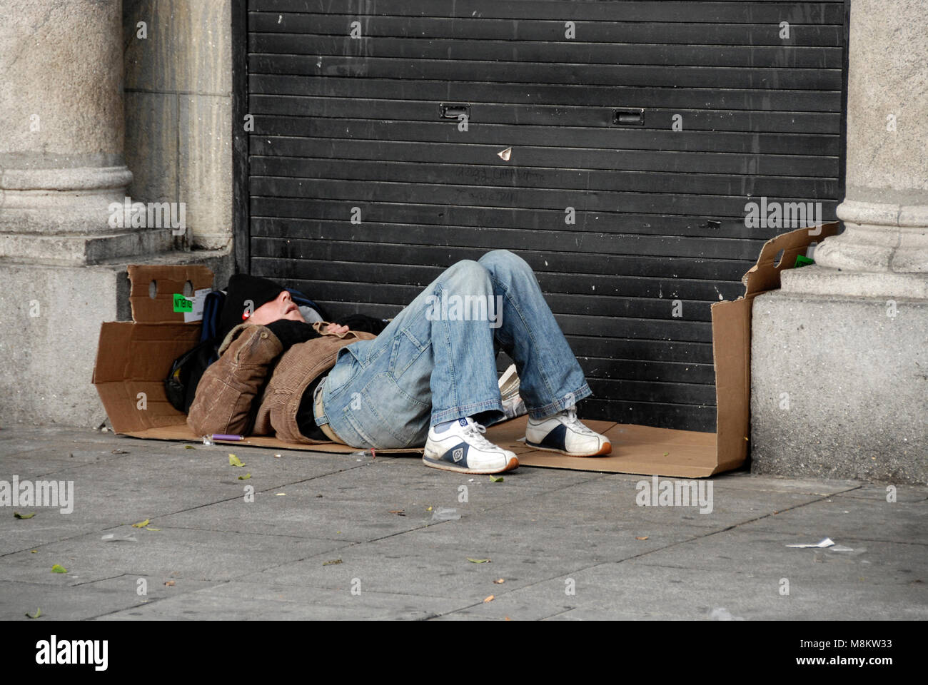 A homeless man sleeping in a doorway in O'Connell Street in Dublin ...