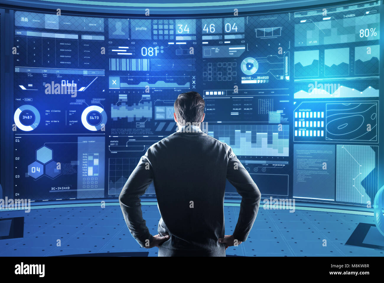 Attentive programmer looking concentrated while standing in front of ...