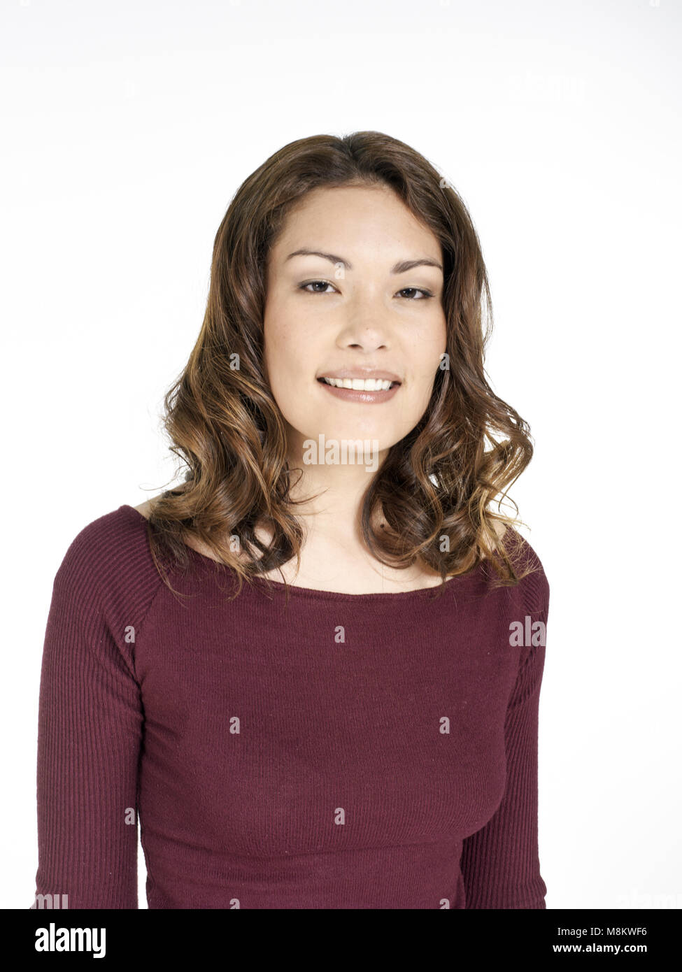 Studio portrait of young East Asian female in her twenties against a ...