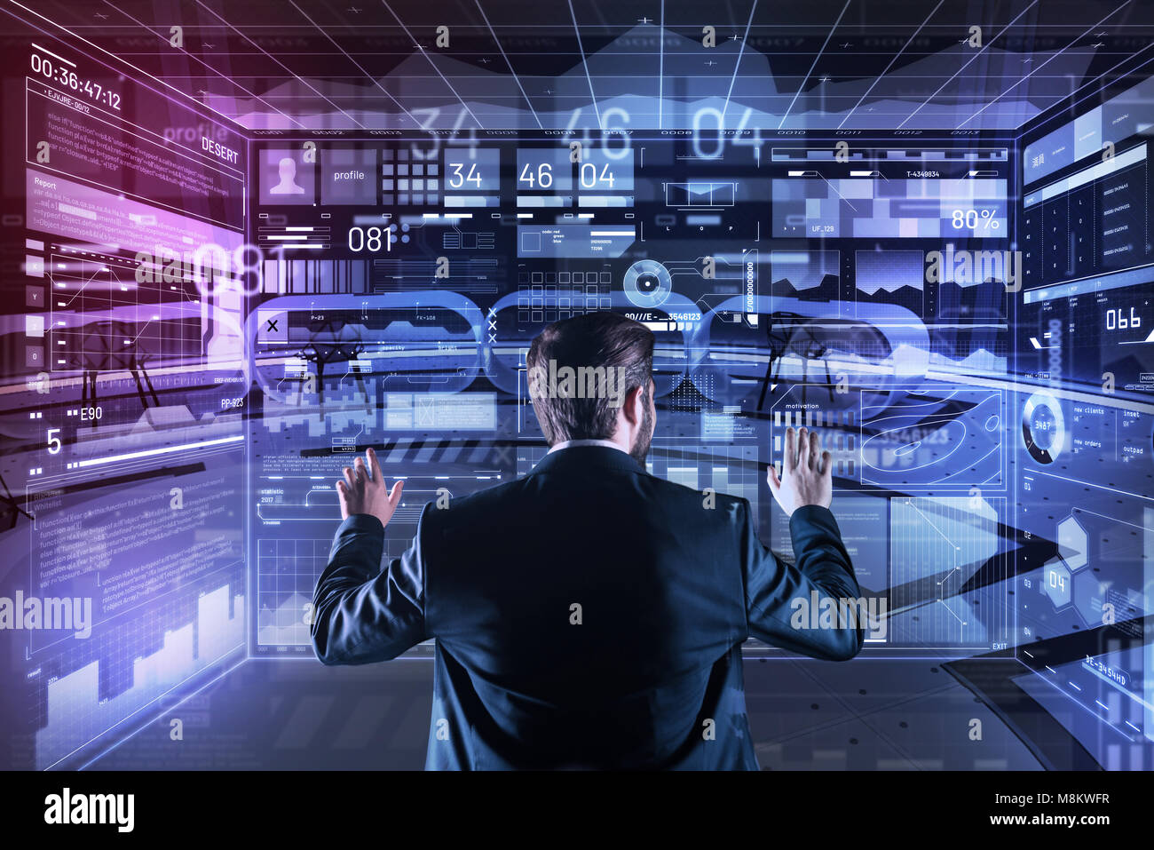 Smart programmer looking concentrated while working with a transparent ...