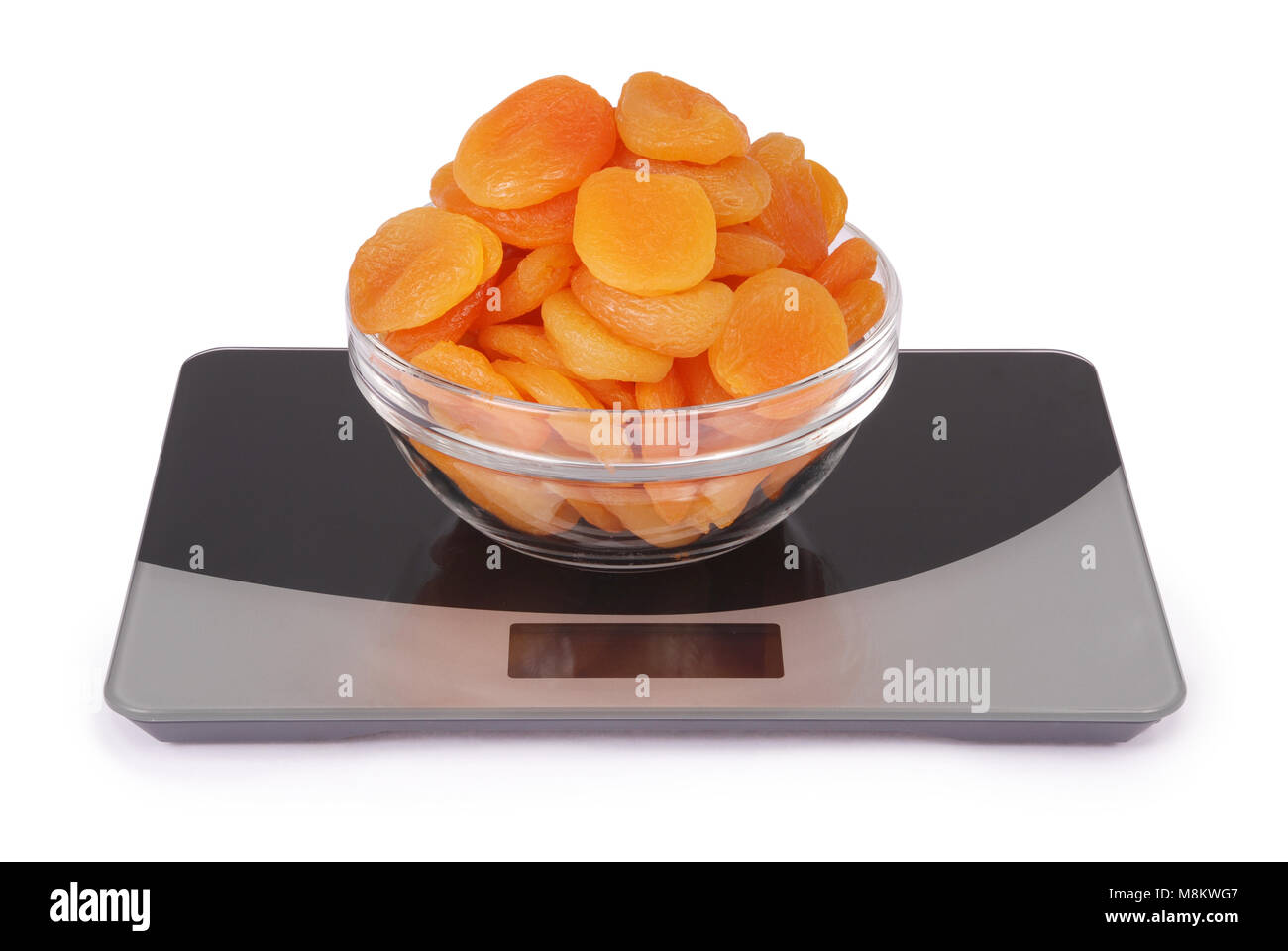 Dried apricot on kitchen scale isolated on white background Stock Photo ...