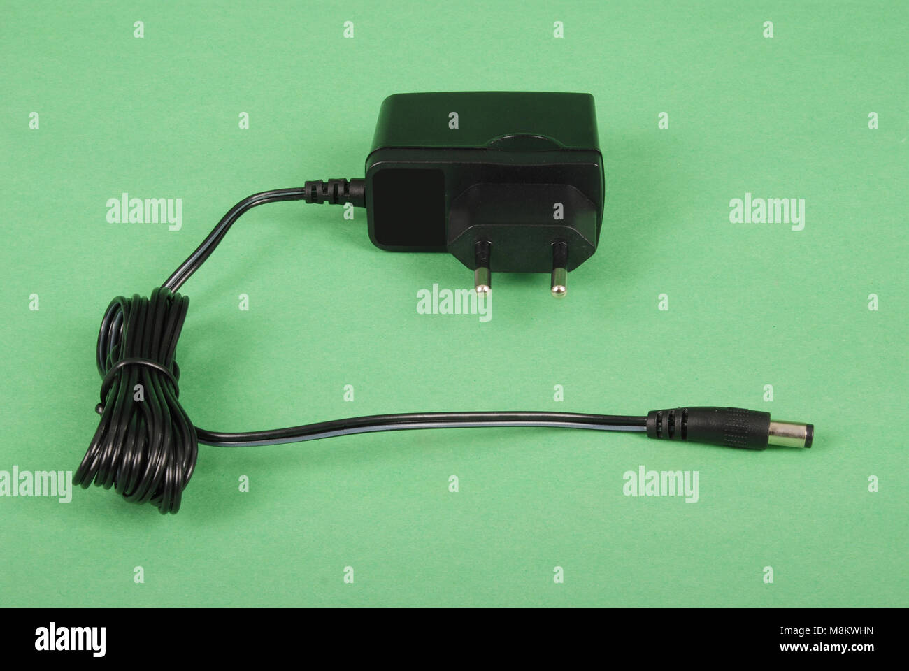 Electric shaver charger isolated on green background Stock Photo - Alamy