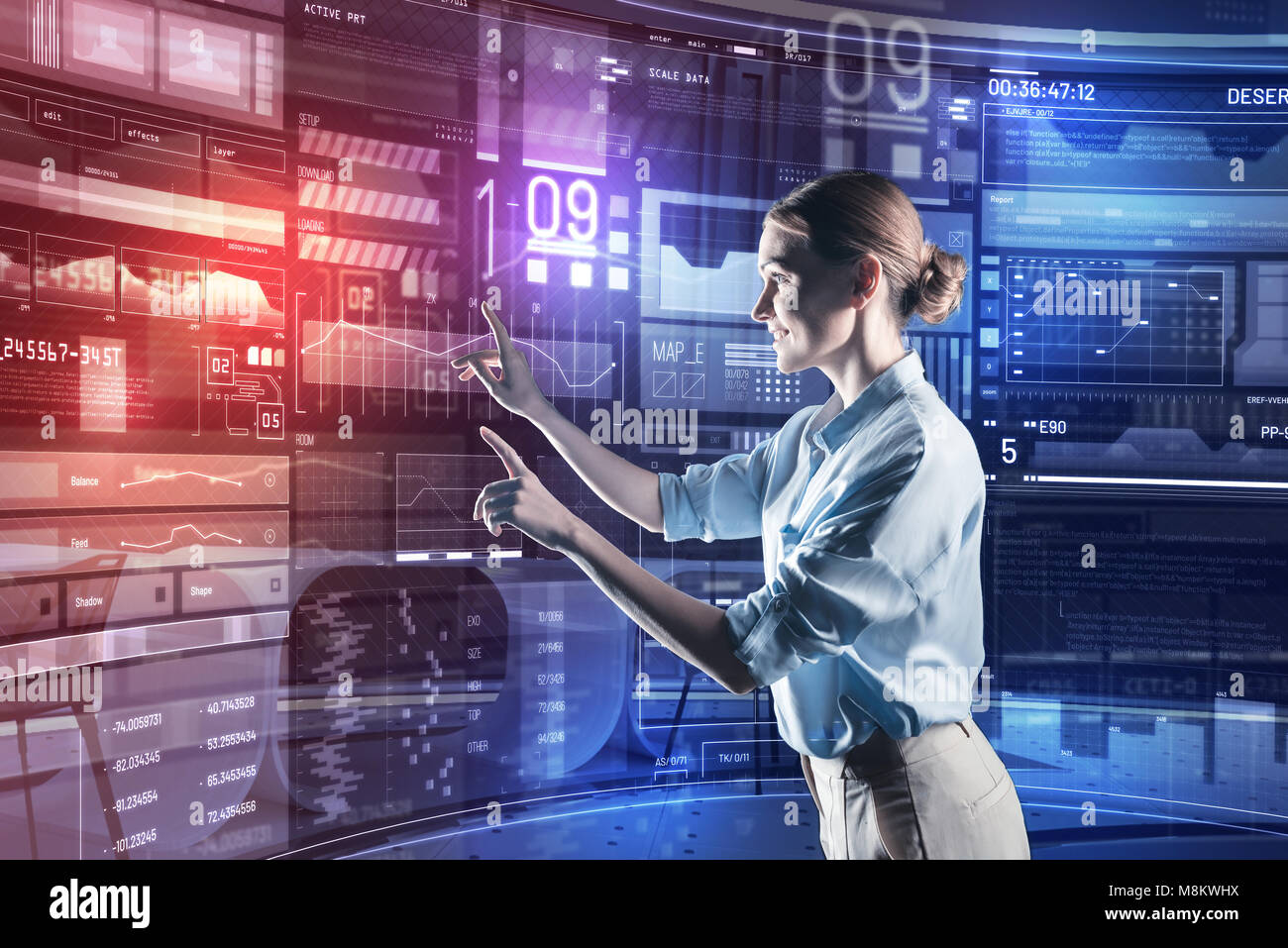 Professional programmer smiling and looking glad while working Stock ...