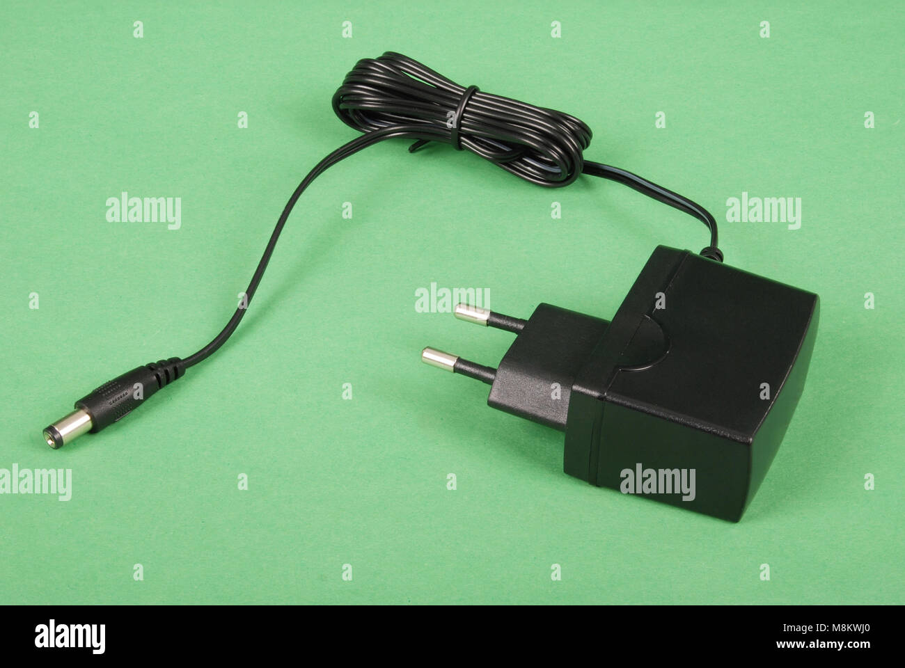 Electric shaver charger isolated on green background Stock Photo - Alamy