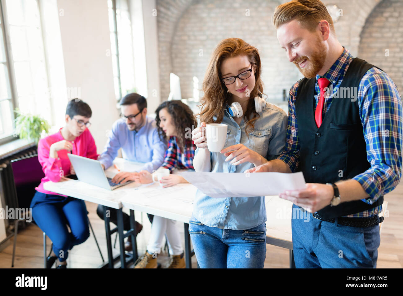 Coworking colleagues having conversation at workplace Stock Photo - Alamy