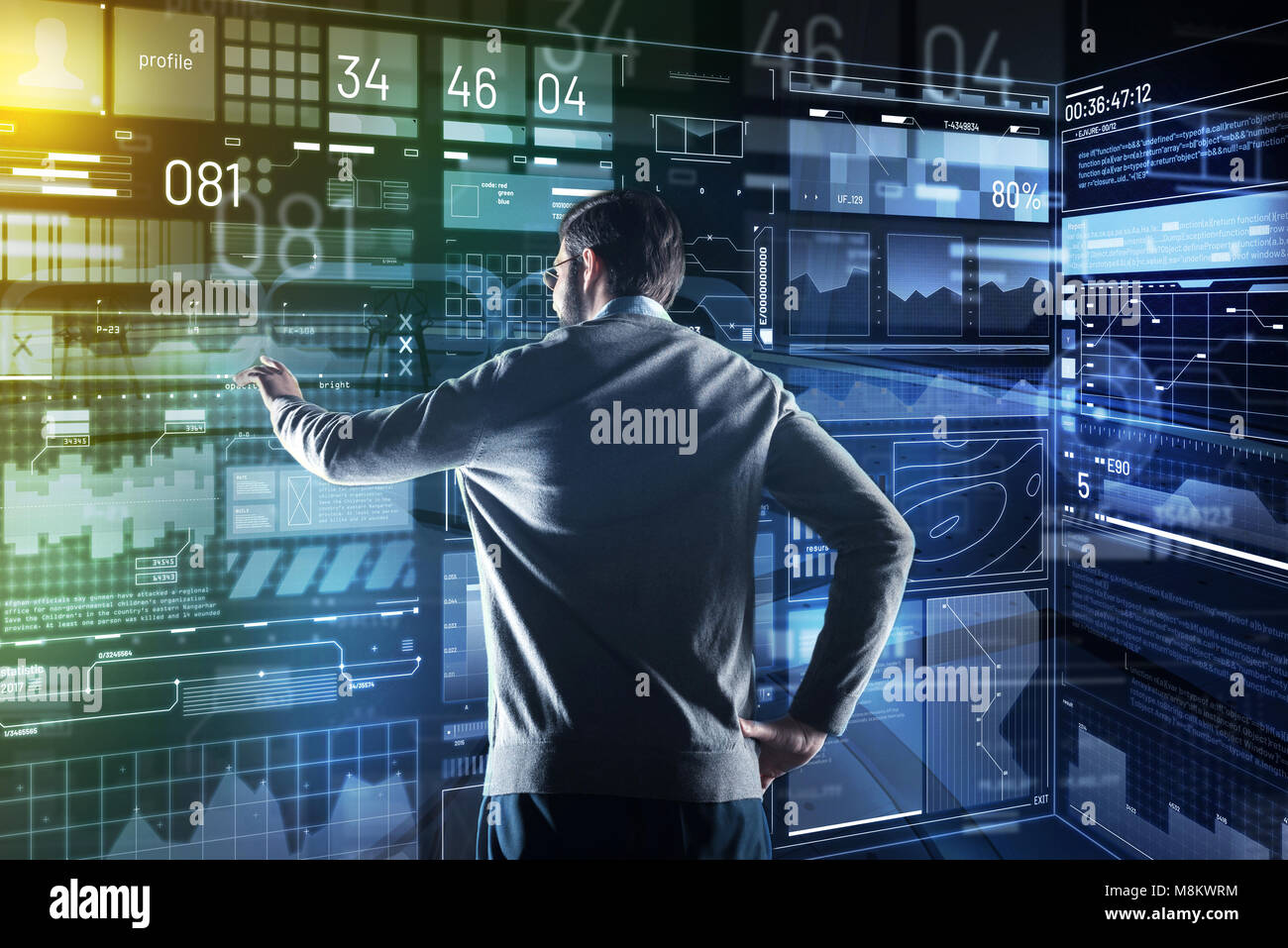 Careful programmer touching the screen while working with personal information Stock Photo - Alamy