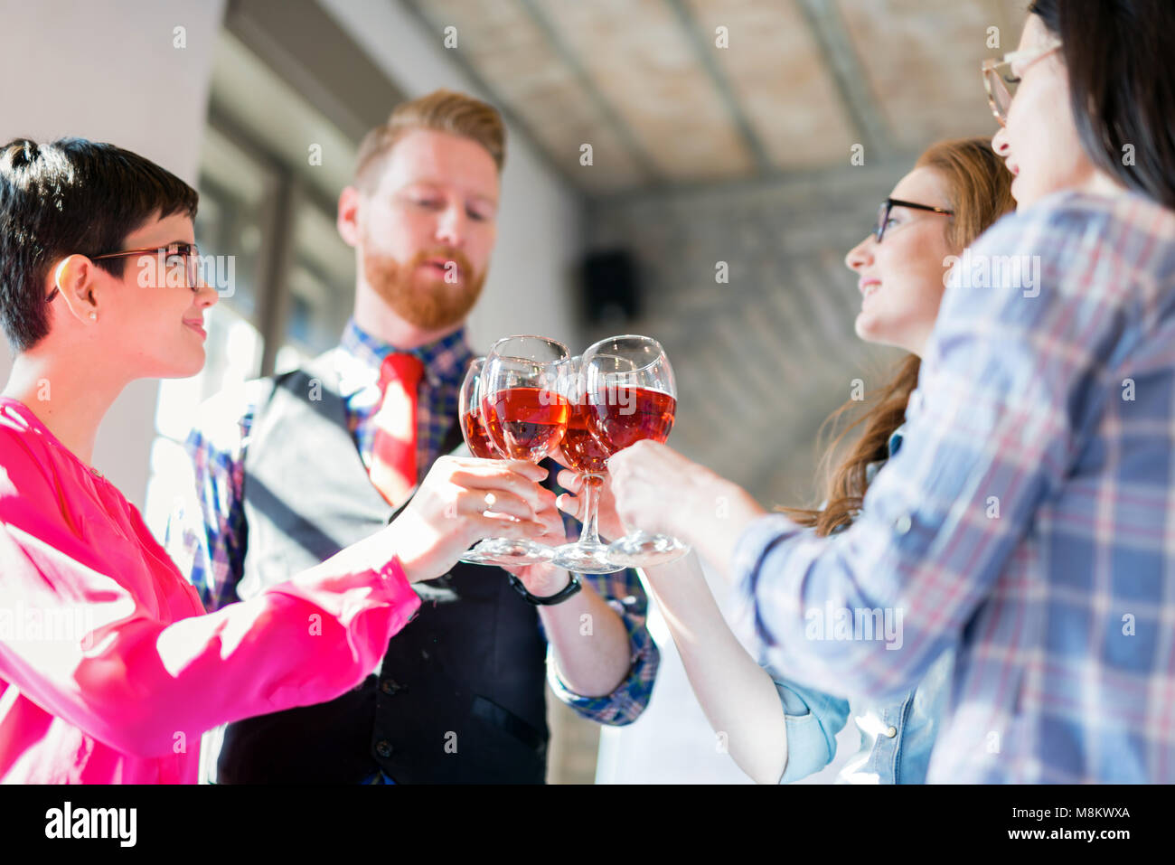 Office colleagues celebrating achievement of company goals Stock Photo ...