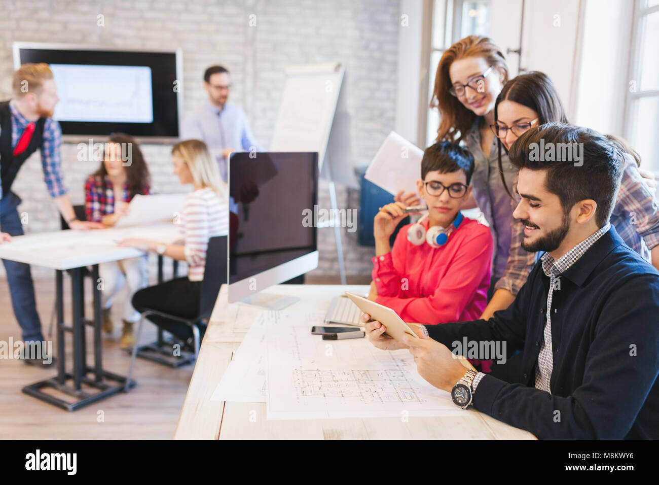 Picture of architects working together in office Stock Photo - Alamy