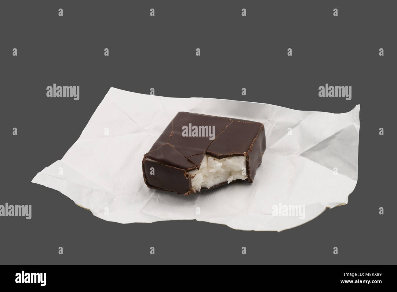 Snack chocolate candy with white stuffing. Isolated on a black ...