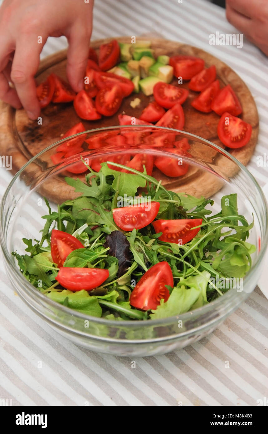 Process of Preparing Healthy Salad. Red Tomato on Wooden Board. Process ...
