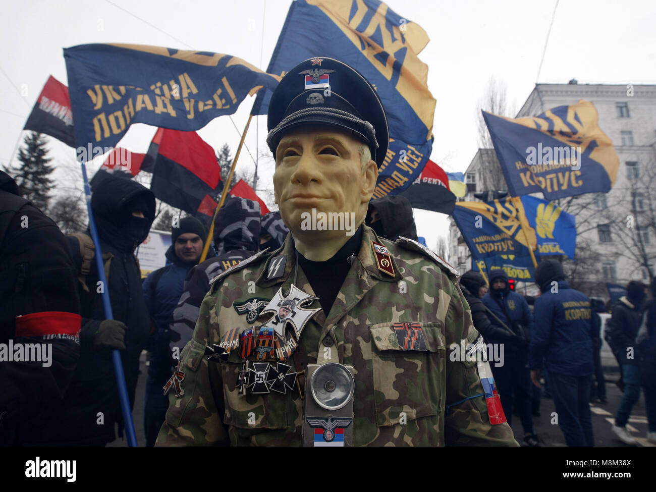Kiev, Ukraine. 18th Mar, 2018. An activist wearing a mask depicting ...
