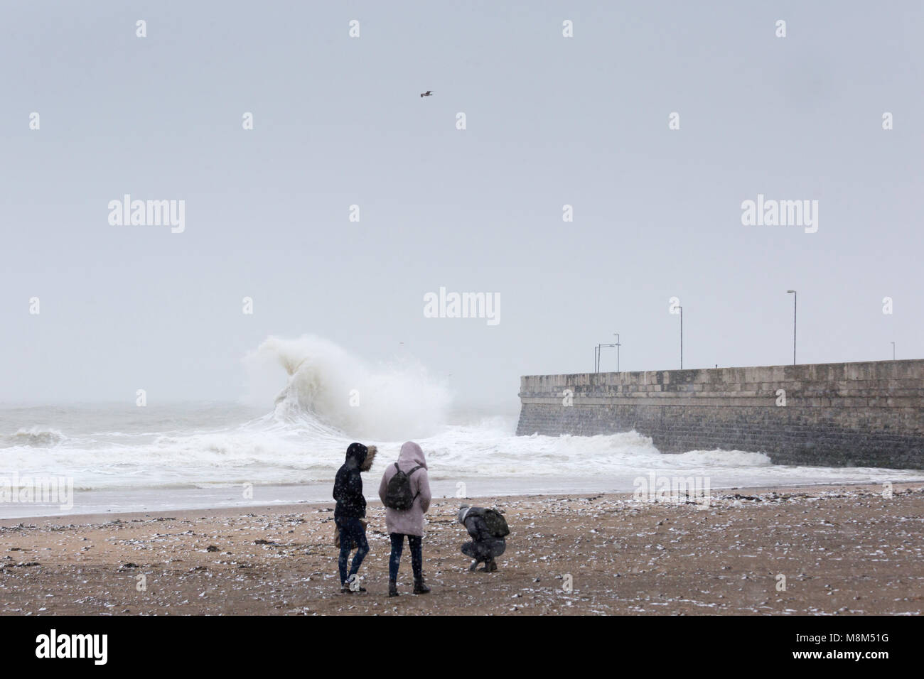 Ramsgate, Kent, UK 18th March, 2018. Three young people on the beach ...