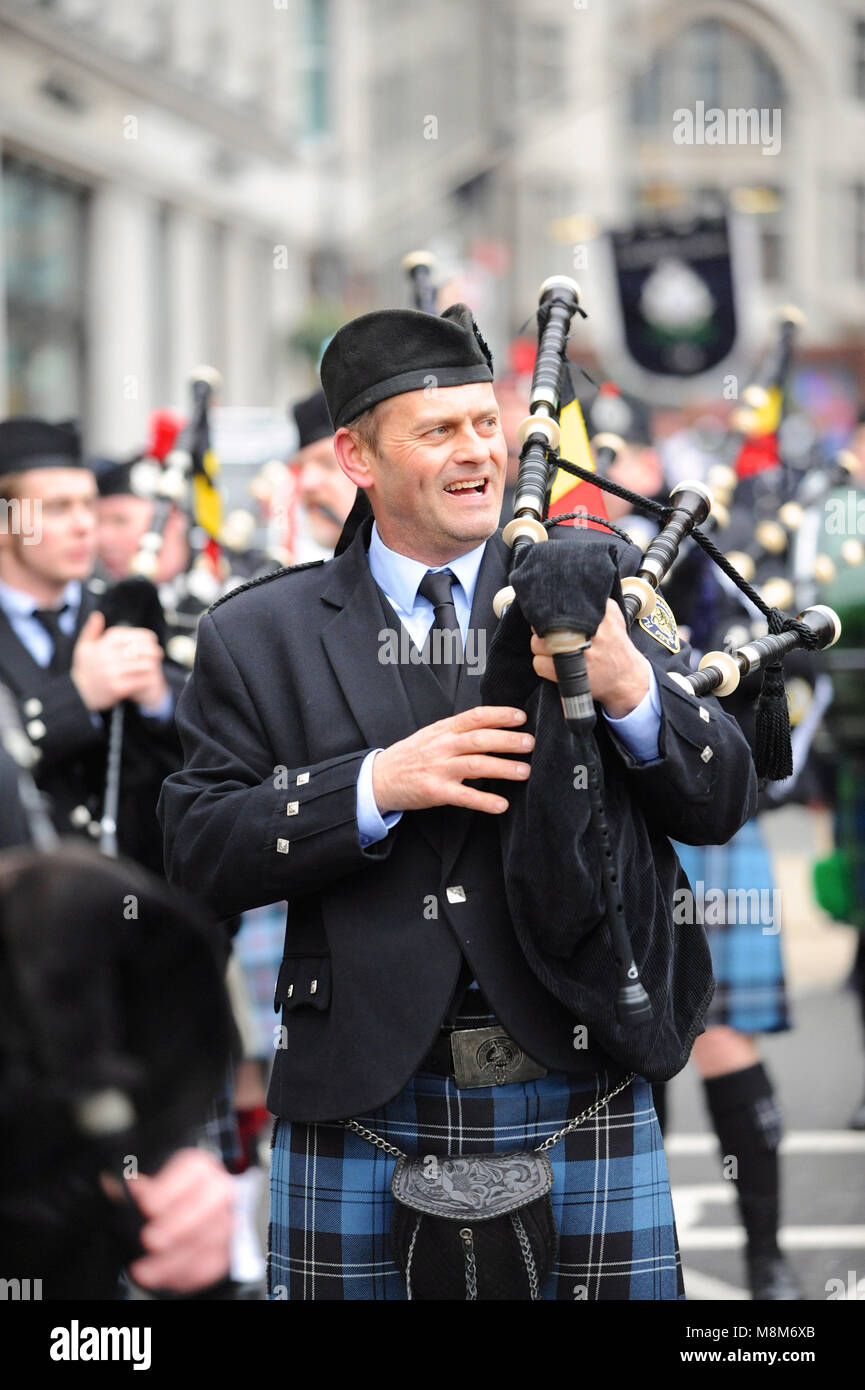 London, UK. 18th March, 2018. An Irish bagpiper from the Maine Public ...