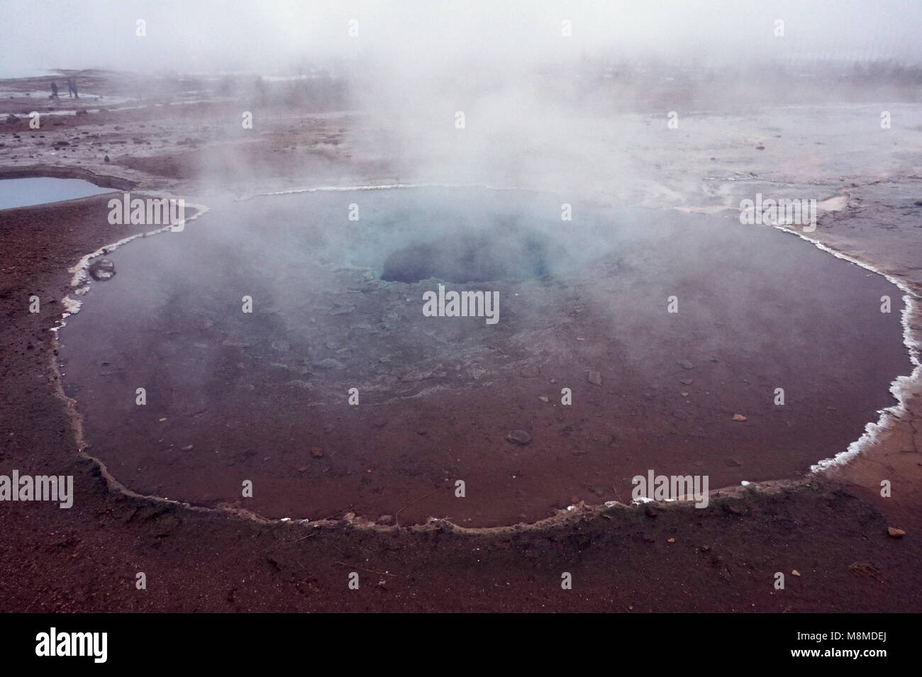 Steaming hot pools coloured by minerals at Haukadalur geothermal area ...