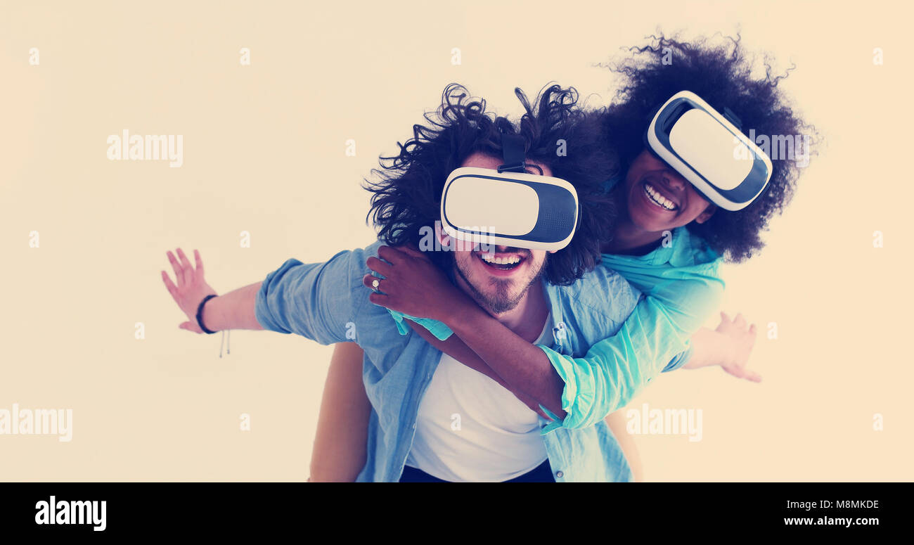 Happy multiethnic couple getting experience using VR headset glasses of ...