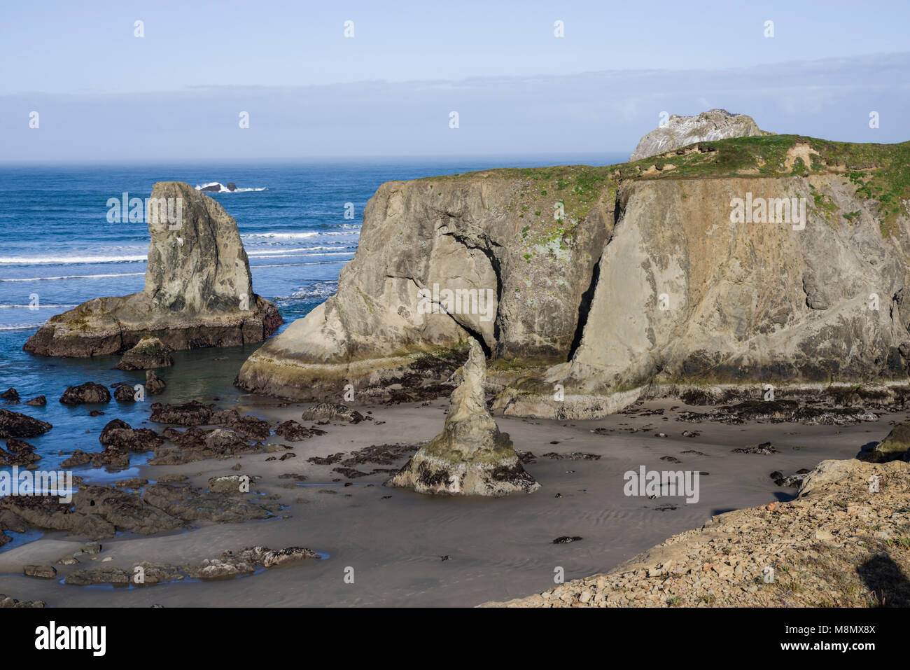Rock outcrops from volcanic eruptions on the beach at Face Rock State ...