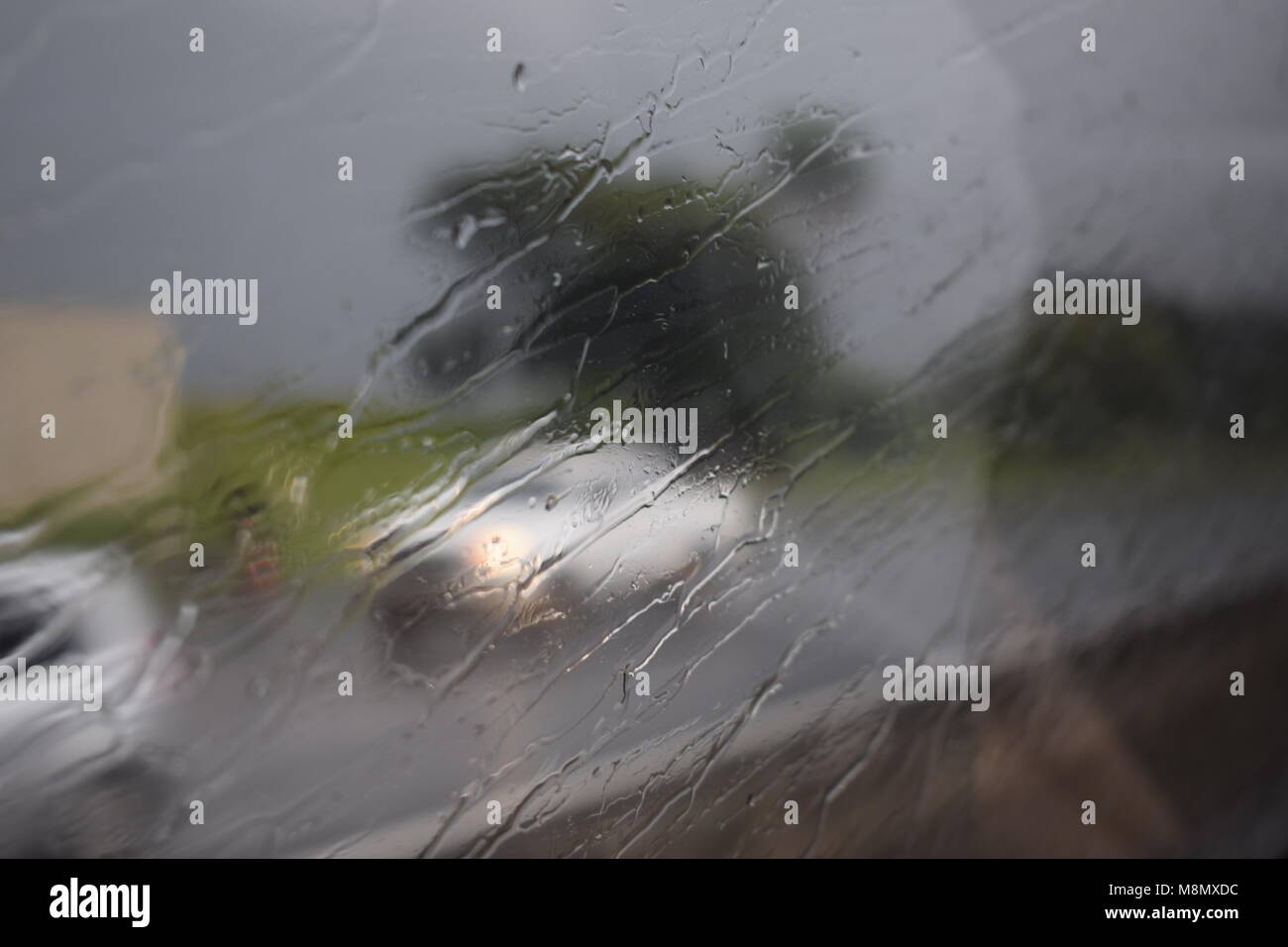 Rainy day bus window with water dripping from the glass Stock Photo - Alamy