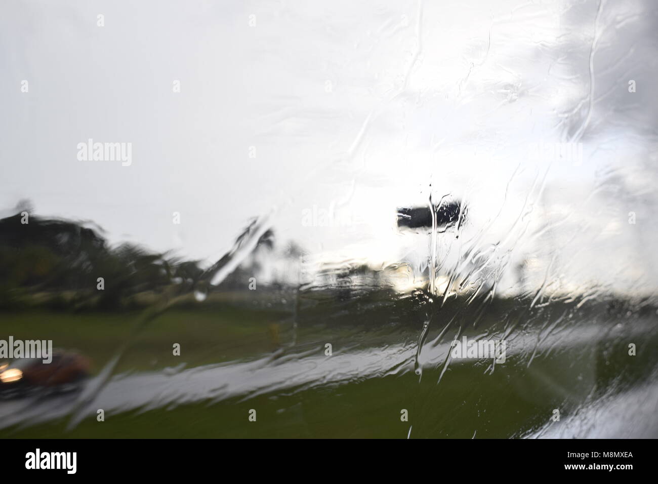 Rainy day bus window with water dripping from the glass Stock Photo - Alamy