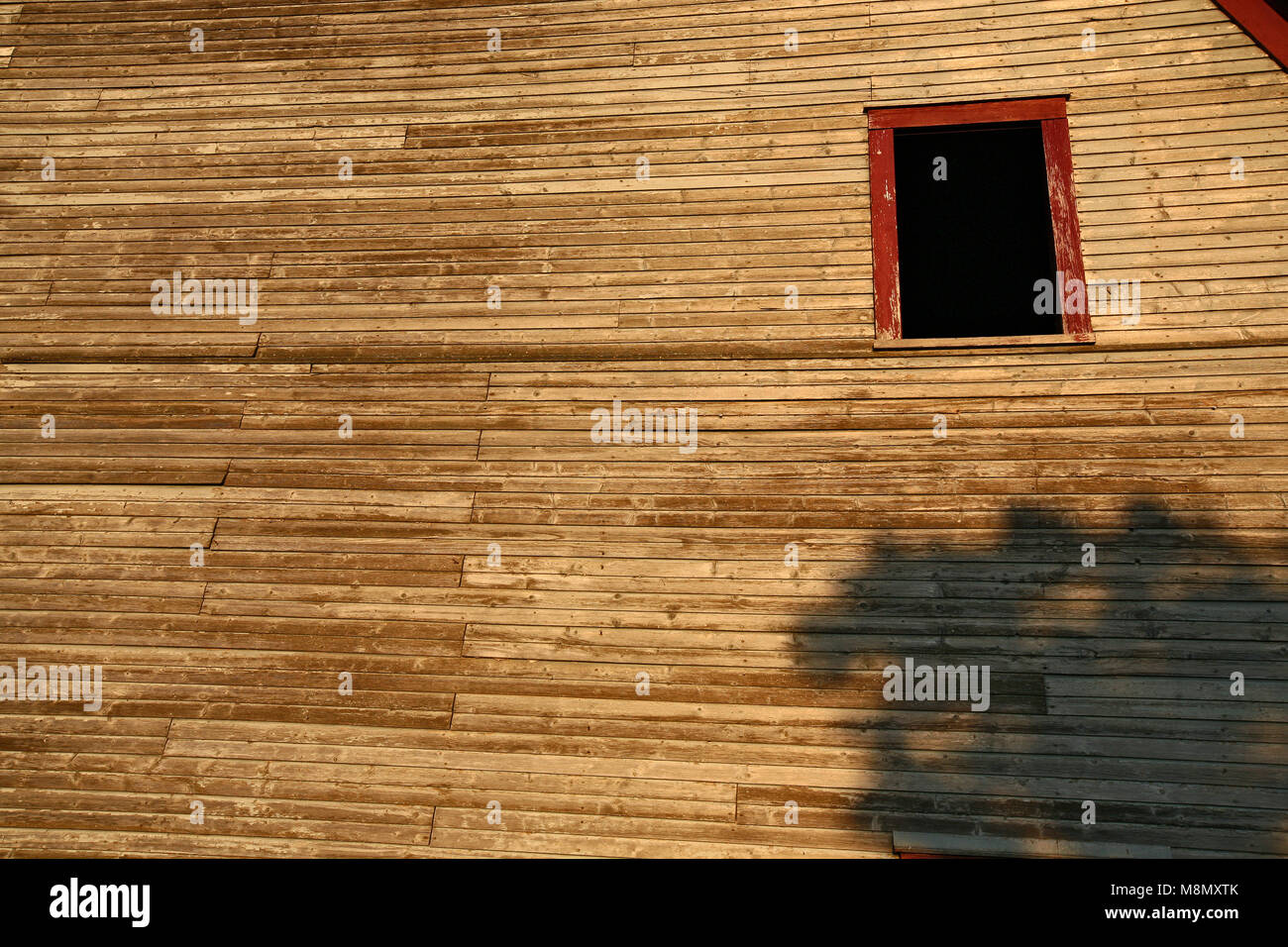 close up of the side of a barn with a window with red trim Stock Photo ...
