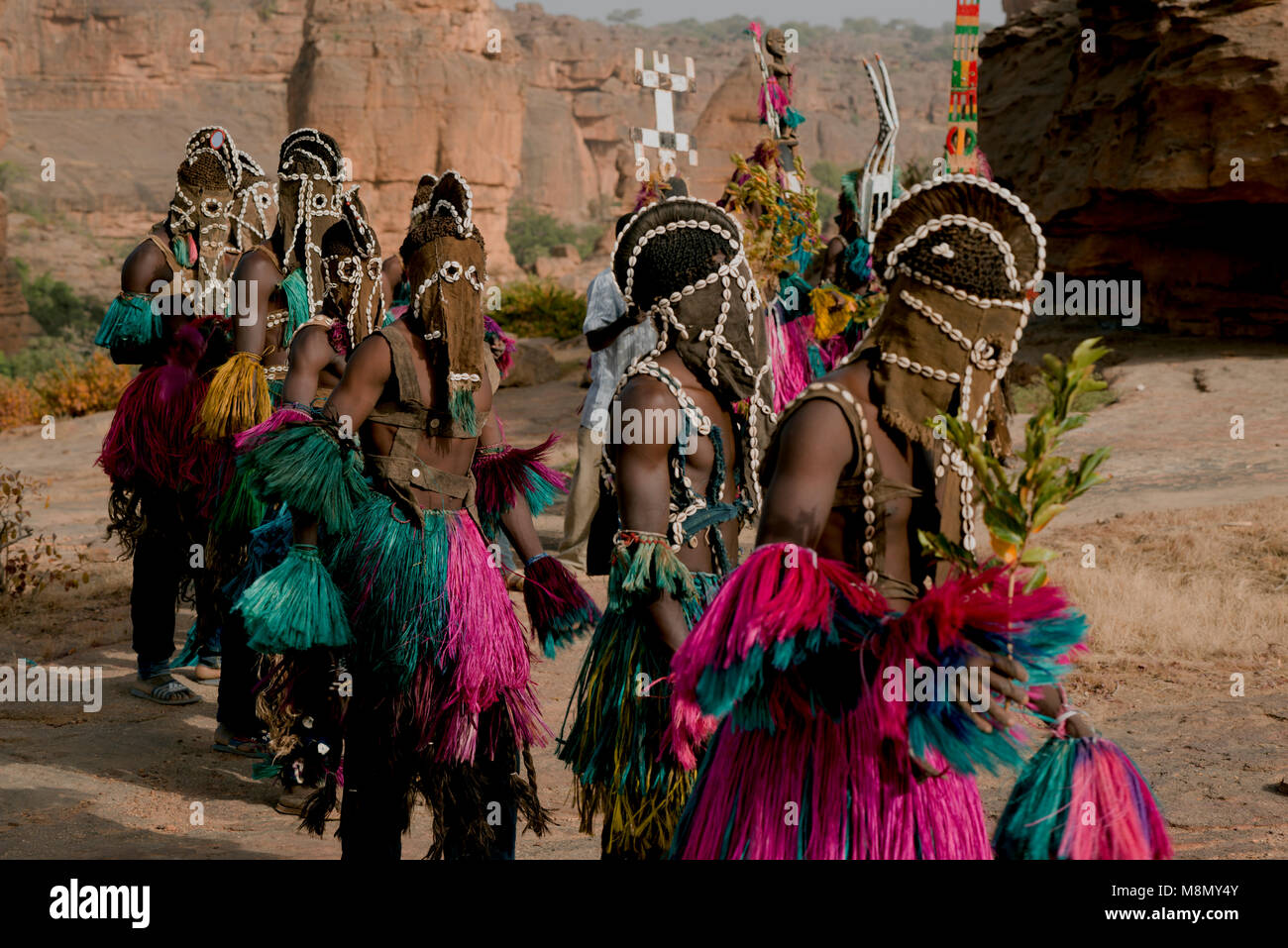 A group of Dogon men performing a ritual tribal masked dance ceremony ...