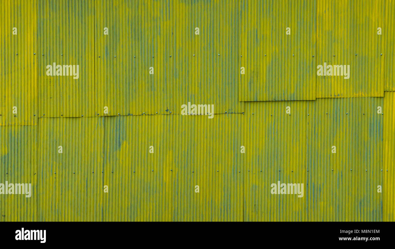 Yellow painted metal sheet roof. industrial background Stock Photo - Alamy
