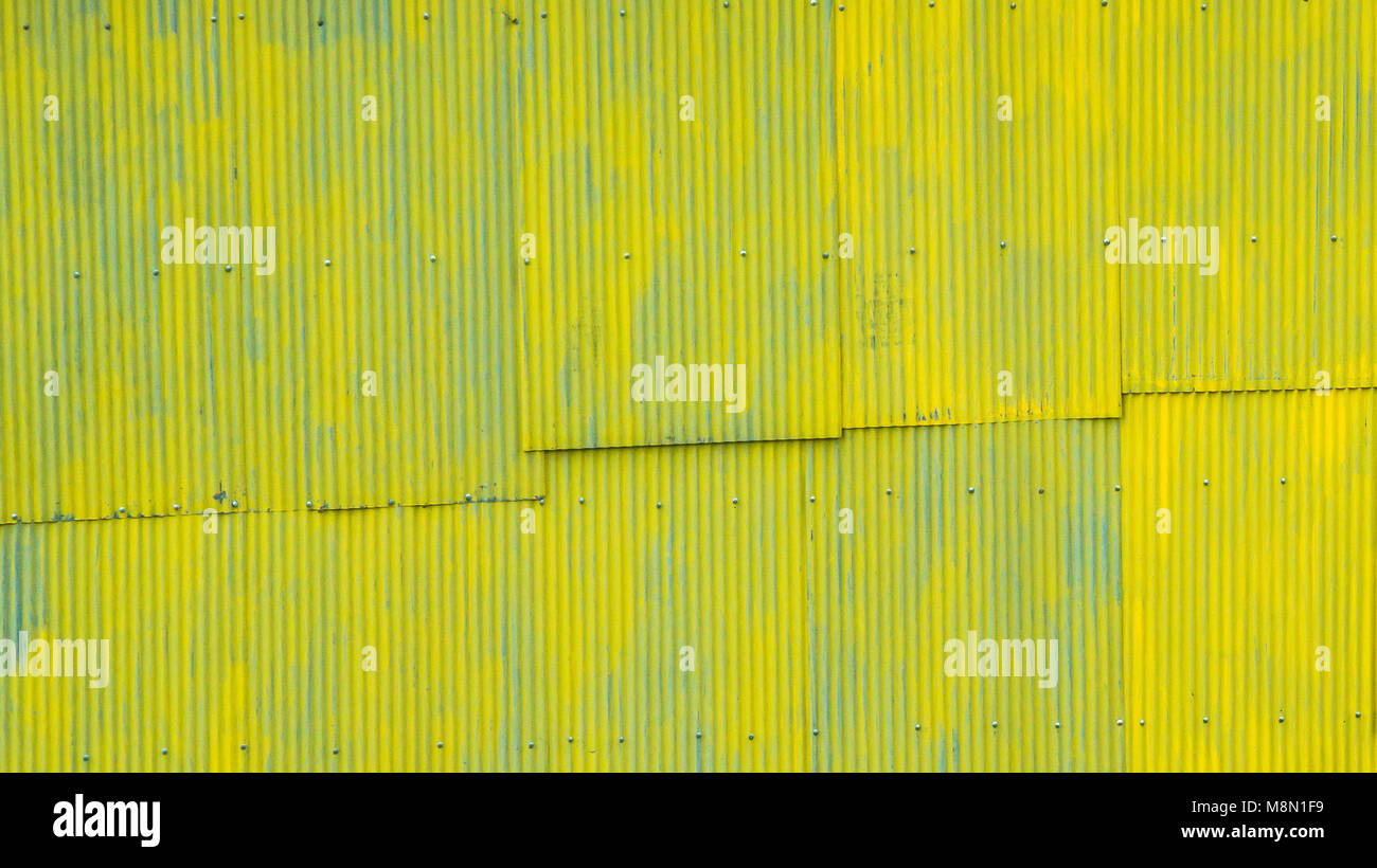 Yellow painted metal sheet roof. industrial background Stock Photo - Alamy